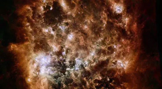 O le ata fou o le Herschel Space Observatory o loʻo faʻaalia ai le Magellanic Cloud Galaxy